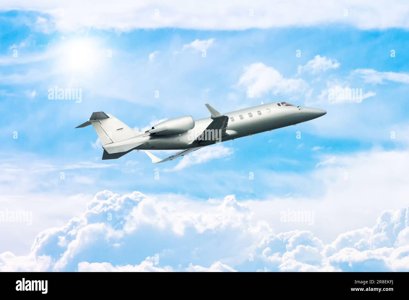 Modern private jet fly in the sky Stock Photo - Alamy