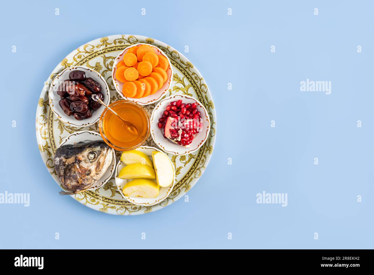 A plate with traditional symbols of Roshashan. honey, head, dates ...