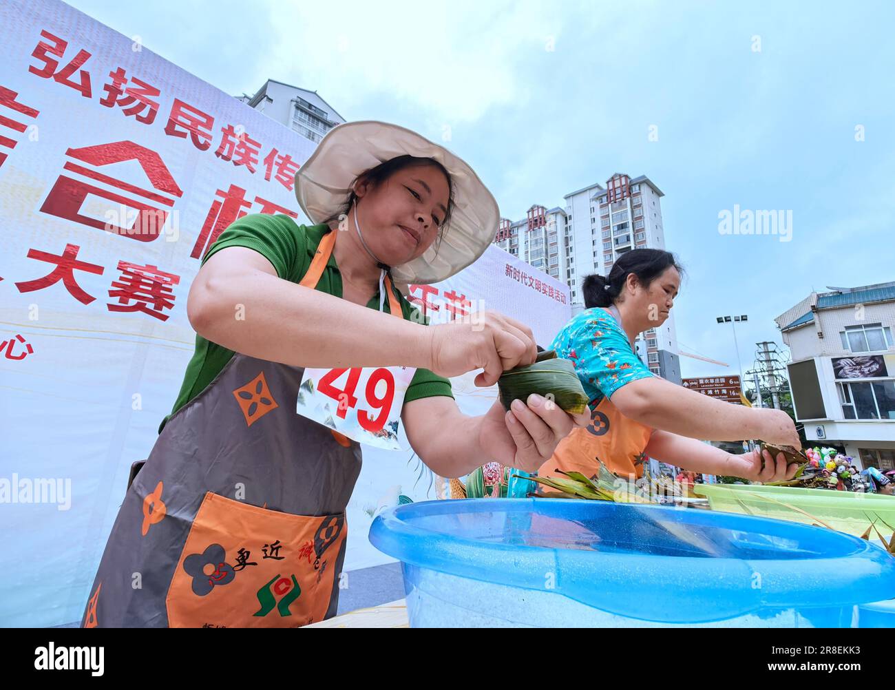 People compete to make zongzi, or sticky rice dumplings in Laibin City ...
