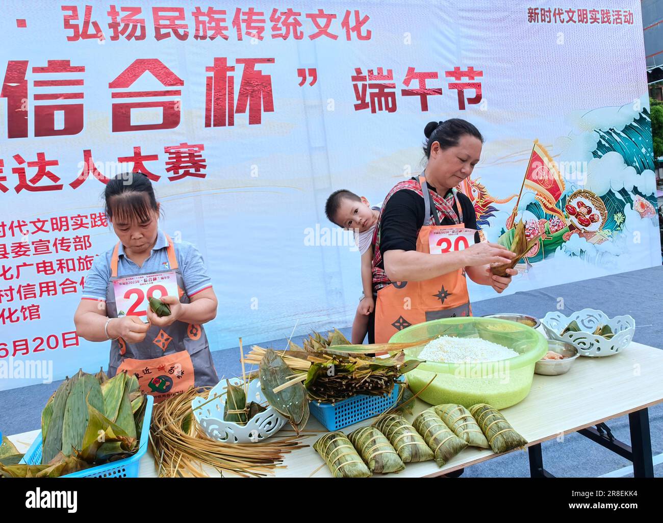 People compete to make zongzi, or sticky rice dumplings in Laibin City ...