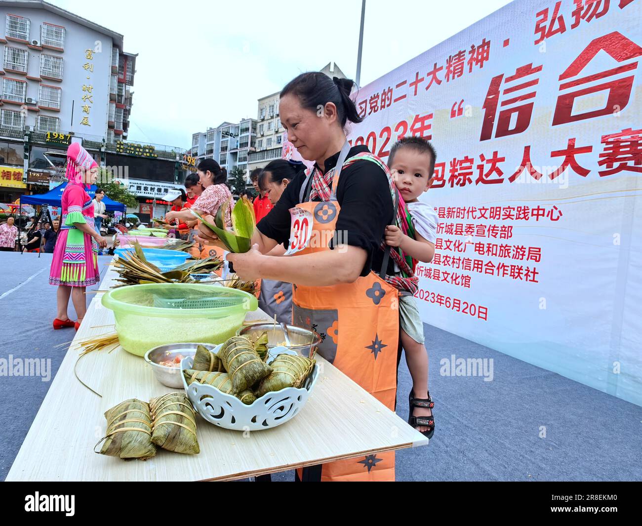 People compete to make zongzi, or sticky rice dumplings in Laibin City ...