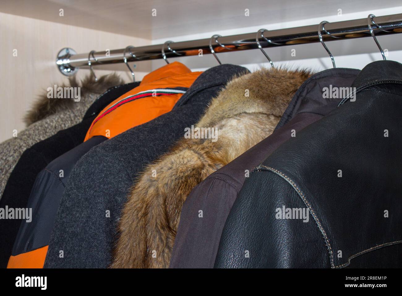 Winter clothes hanged on a clothes rack Stock Photo - Alamy
