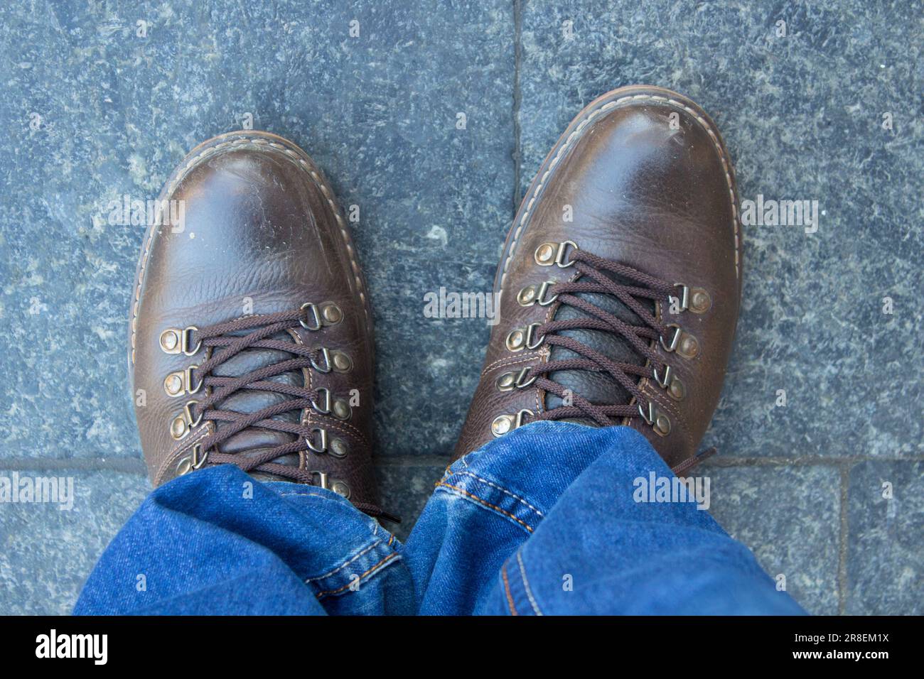 A man stands in tourist boots on a stone slab Stock Photo - Alamy