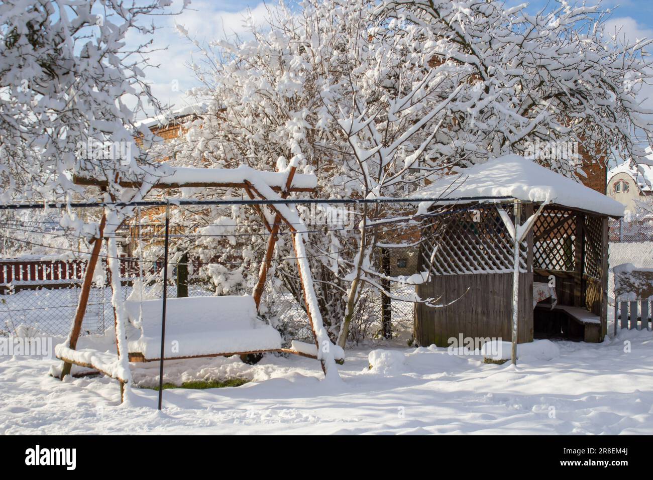 Fairy winter in the courtyard with gazebo and swing Stock Photo - Alamy