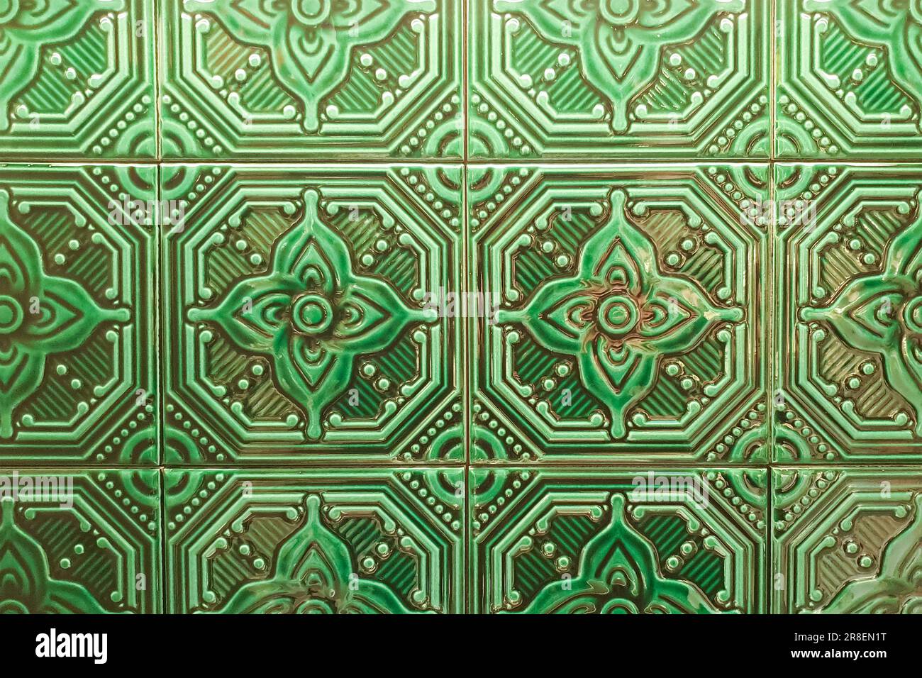 ceramic tile texture full frame. green geometric flower pattern on ...
