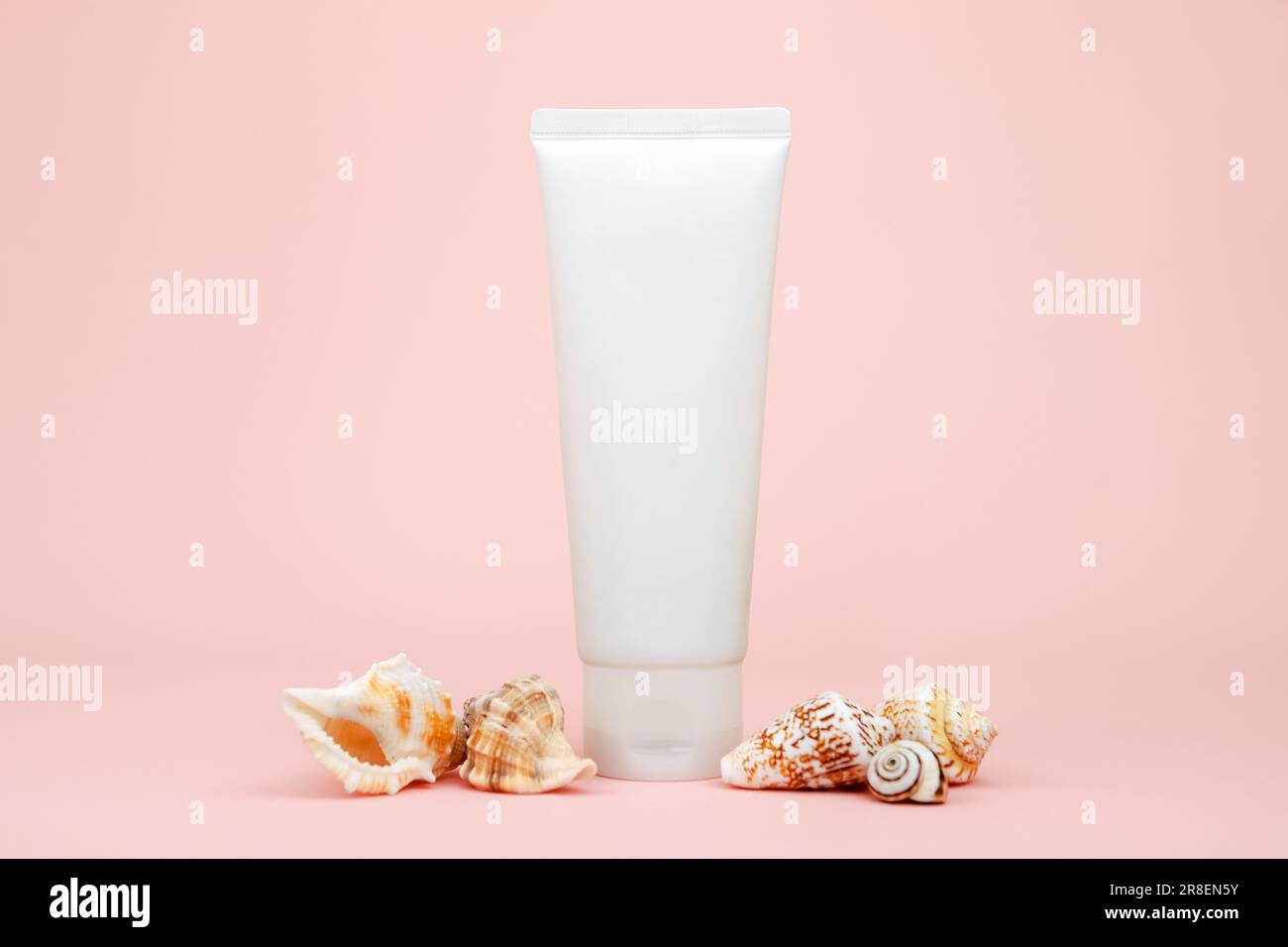 cosmetic cream tube, sea shells on pink background. mockup, skincare ...