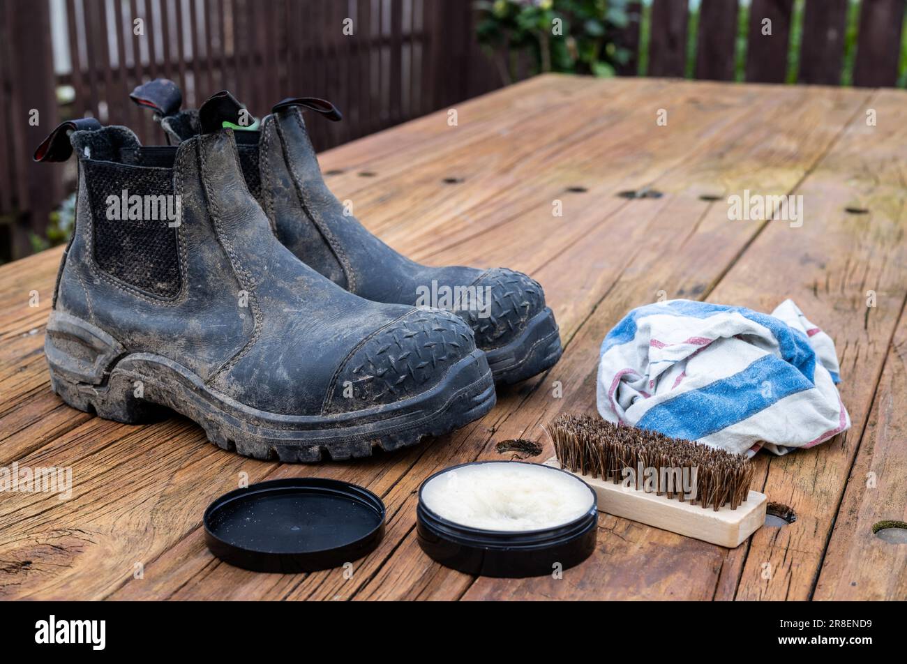 Black pair of leather work boots ready to be clean and wax Stock Photo ...