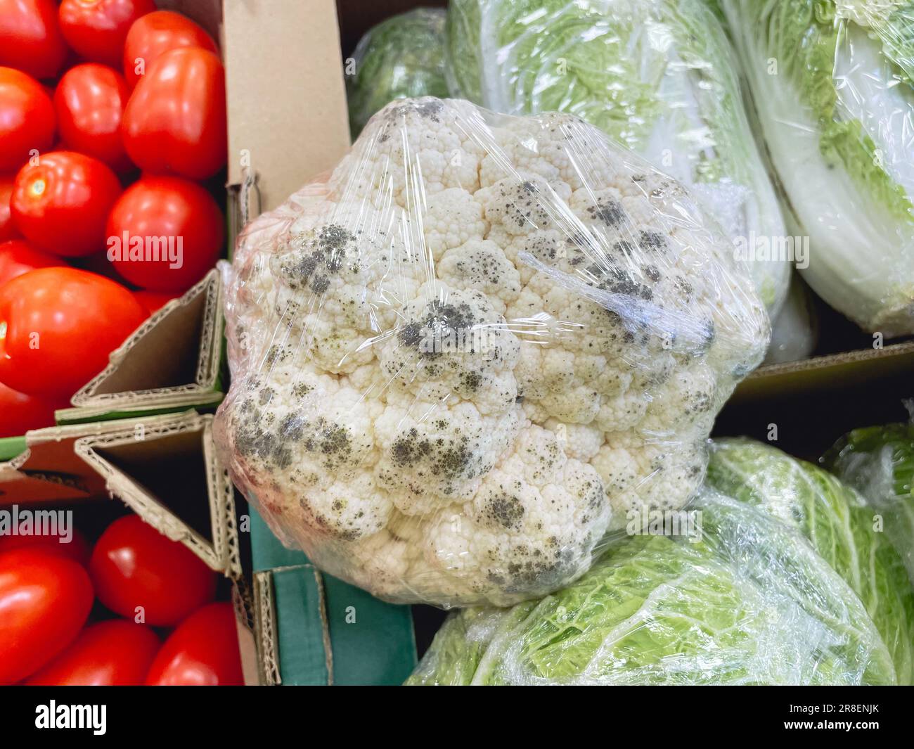 Tainted cauliflower. Black mold on bad cauliflower. Improper storage of ...