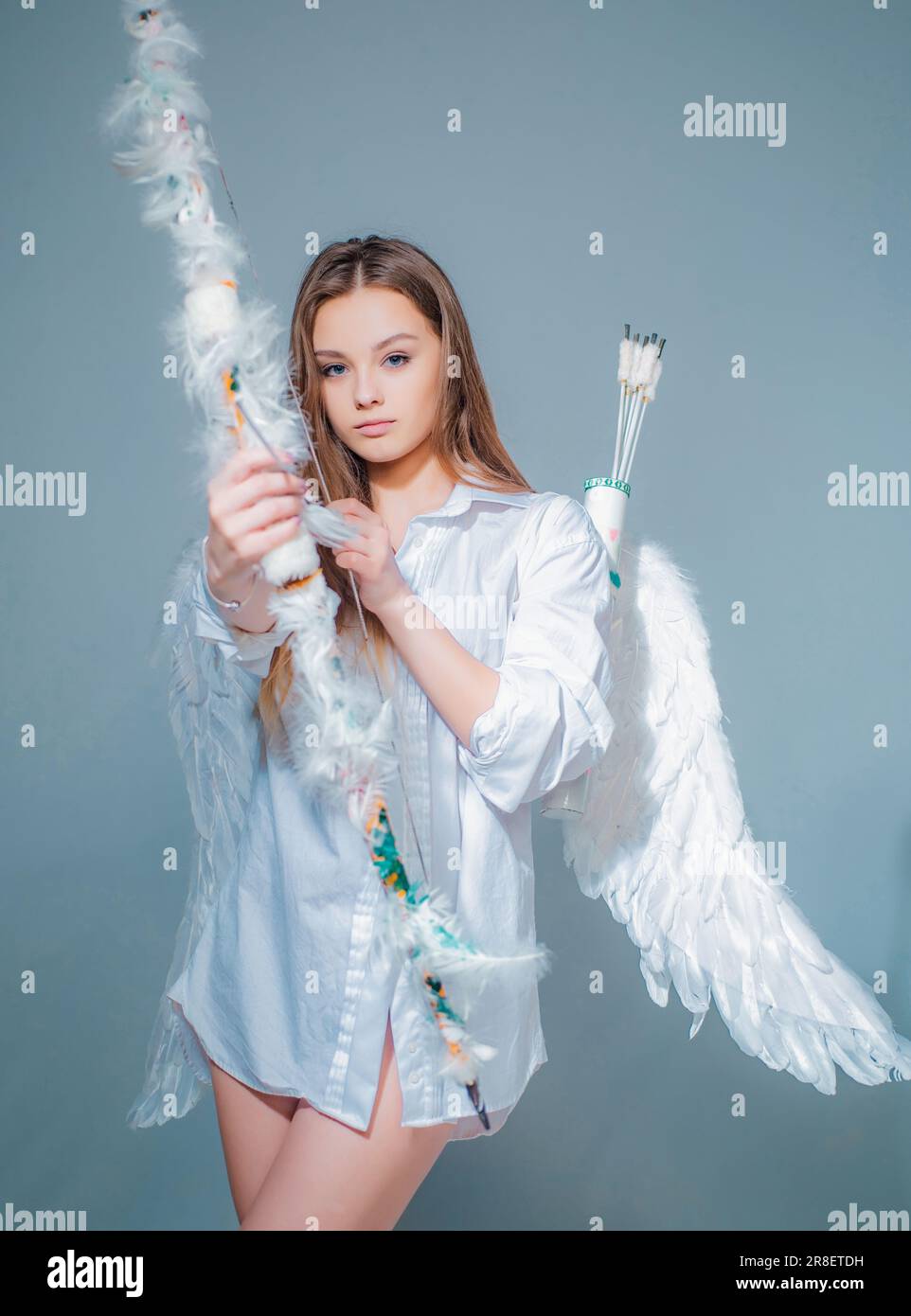 Beauty blue her eyes - charming lady with feather wings. Cupid in ...