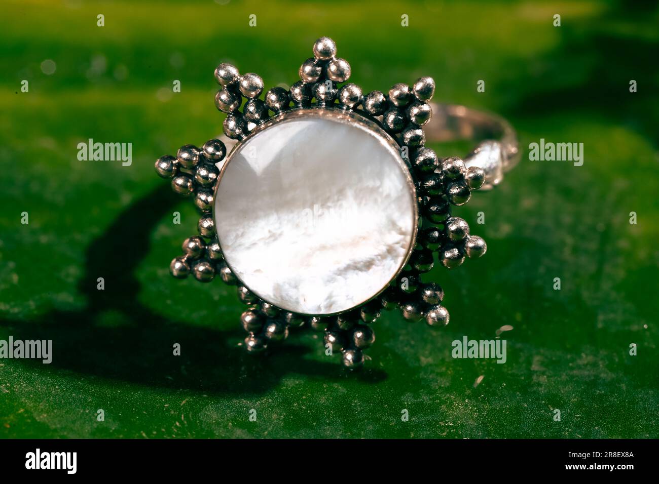 Ring with a white gem Stock Photo - Alamy