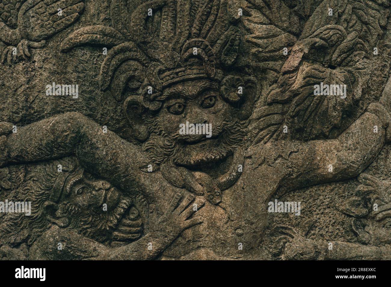 Ancient stone wall carved in sacred monkey forest. Traditional monkey ...