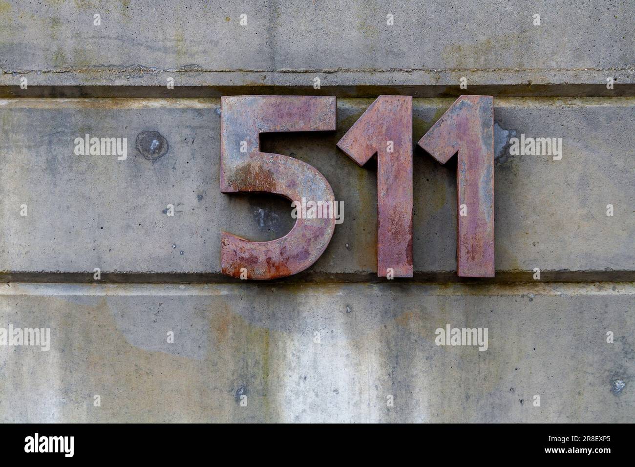 A close-up shot of an aged metal number 511 affixed to a weathered ...