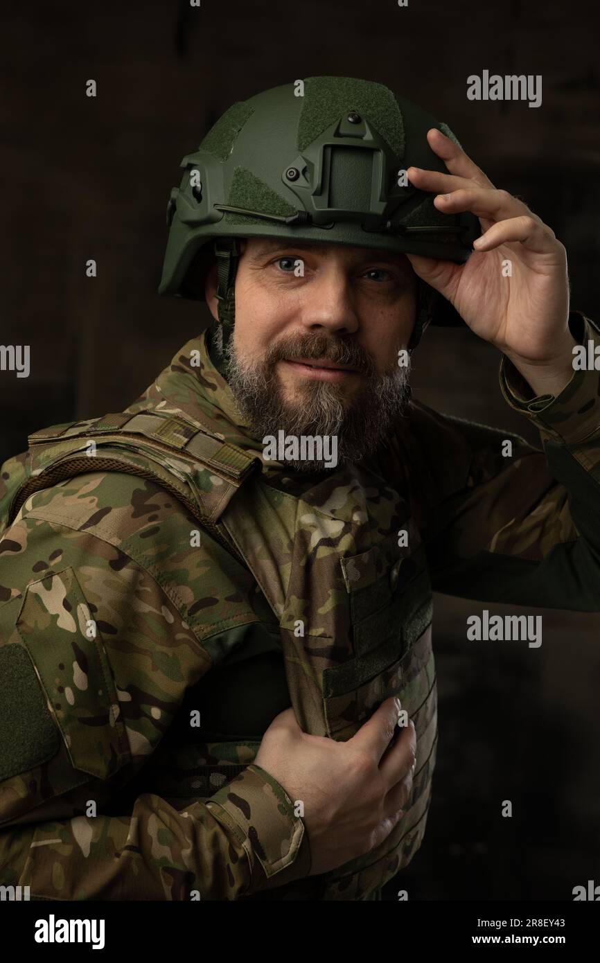 Portrait of a soldier in Combat Uniform wearing at helmet and body ...