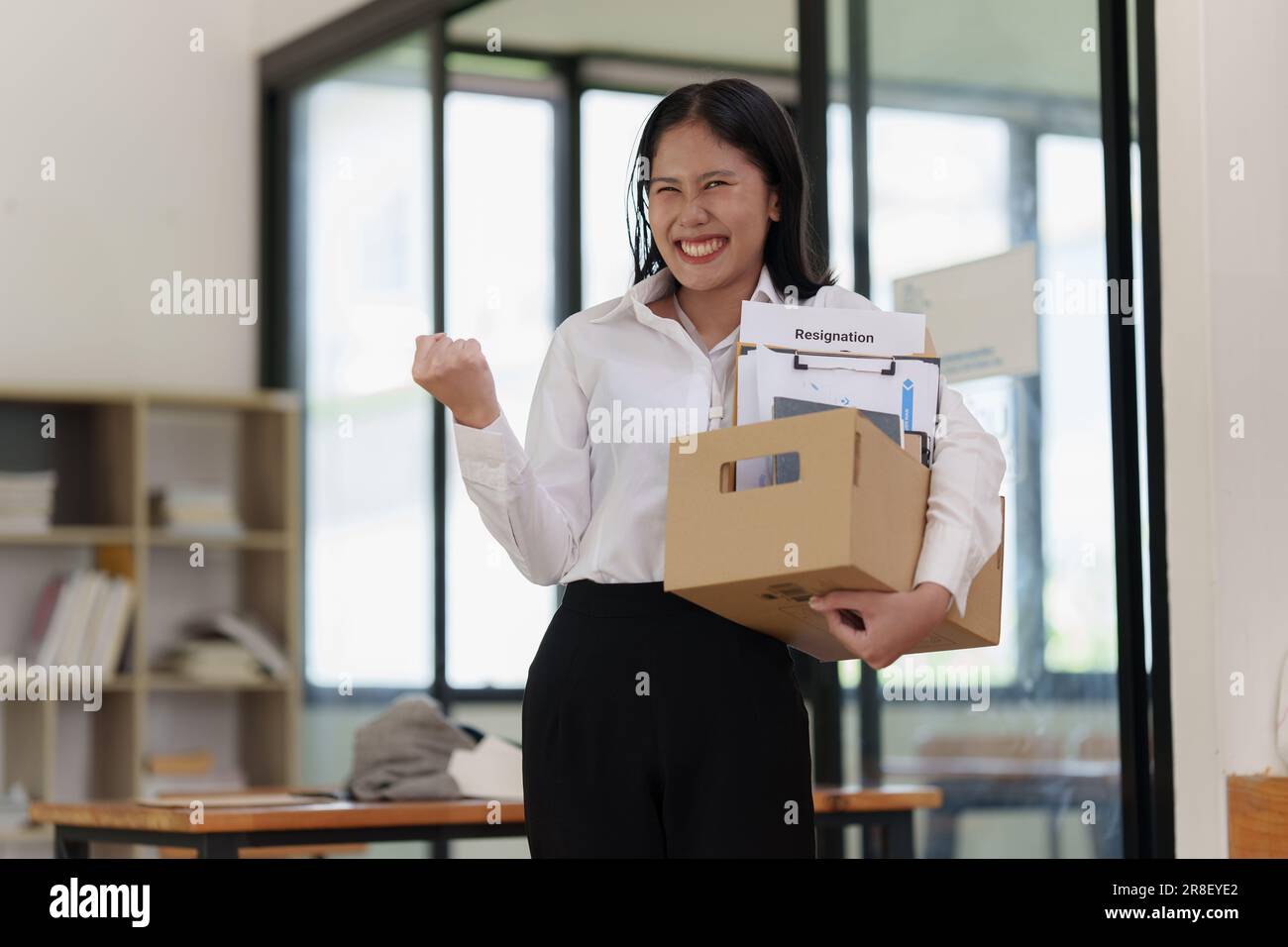 Resignation concept. Employee holding box of belongings in an office ...