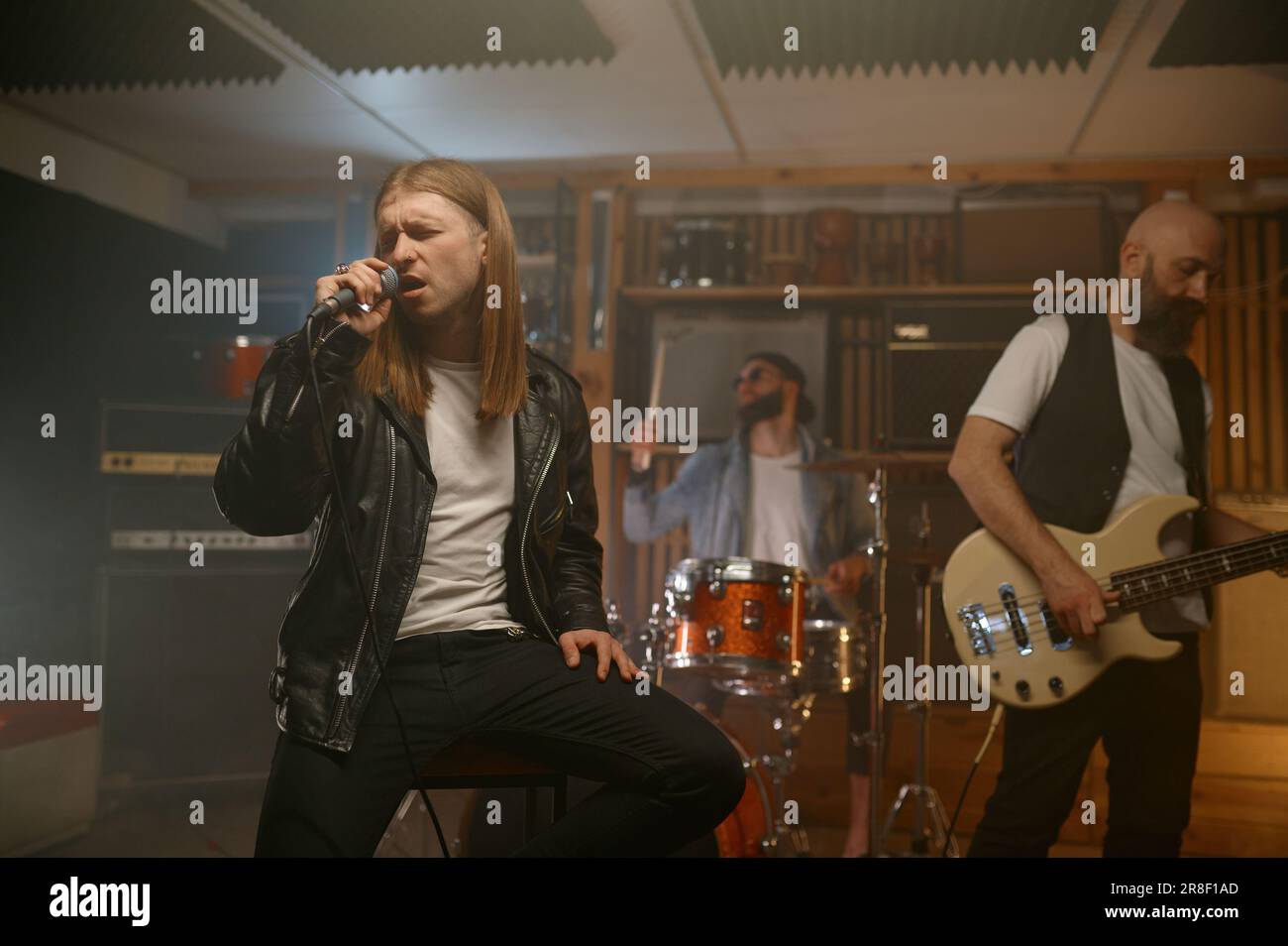 Closed performance of rock band shot with focus on young singer with ...