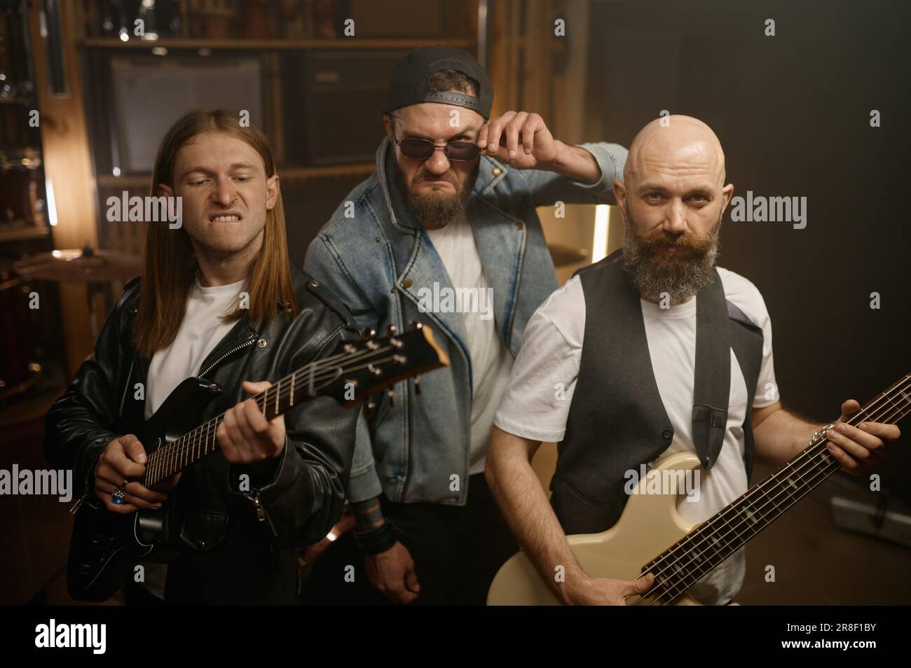 Rock band portrait with rockstar guitar player of different age Stock ...