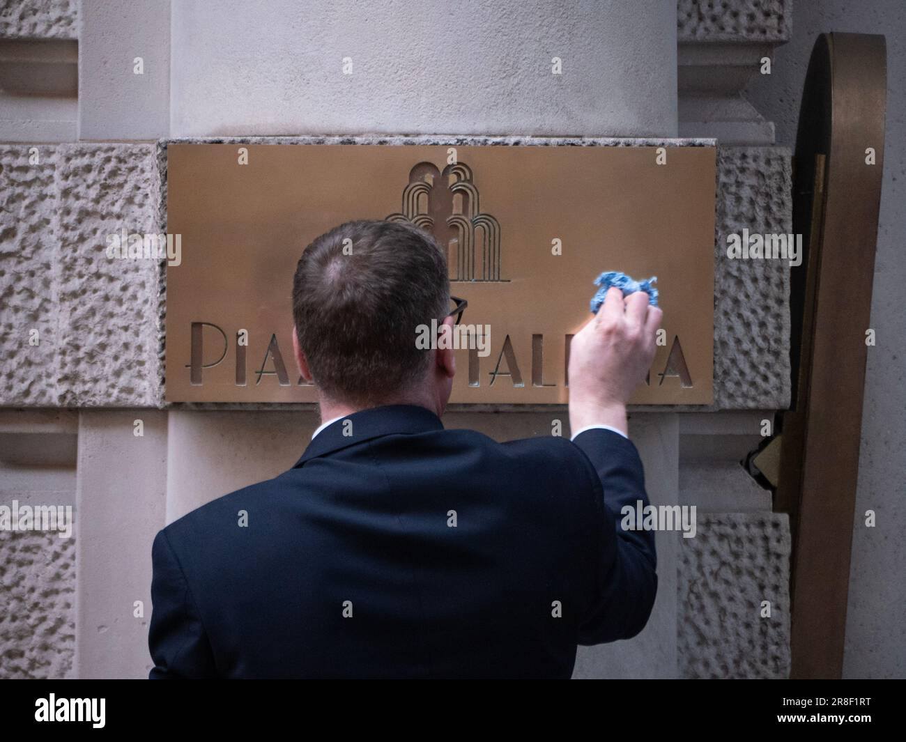 Cleaner polishing sign outside the Piazza Italiana restaurant ...