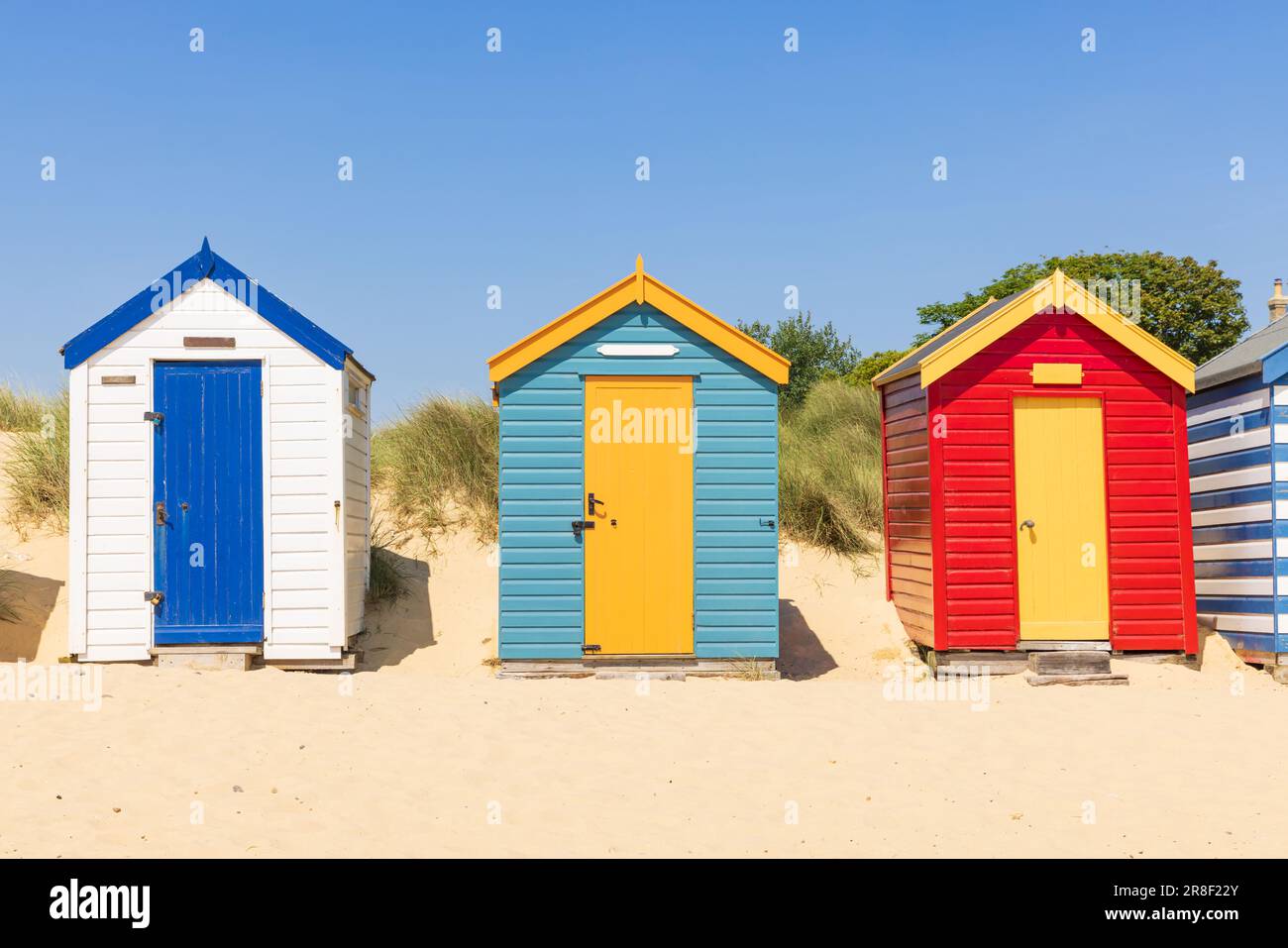 Colourful wooden beach huts on the sandy beach in Southwold, Suffolk ...