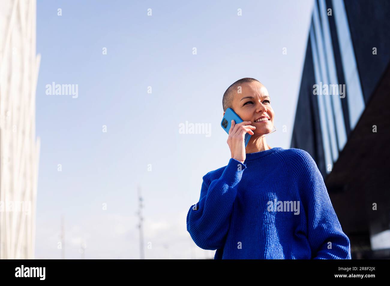 woman with buzz cut talking happy on mobile phone Stock Photo - Alamy