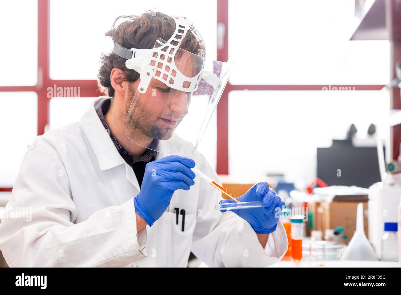 Young man researcher carrying out scientific research in a laboratory ...