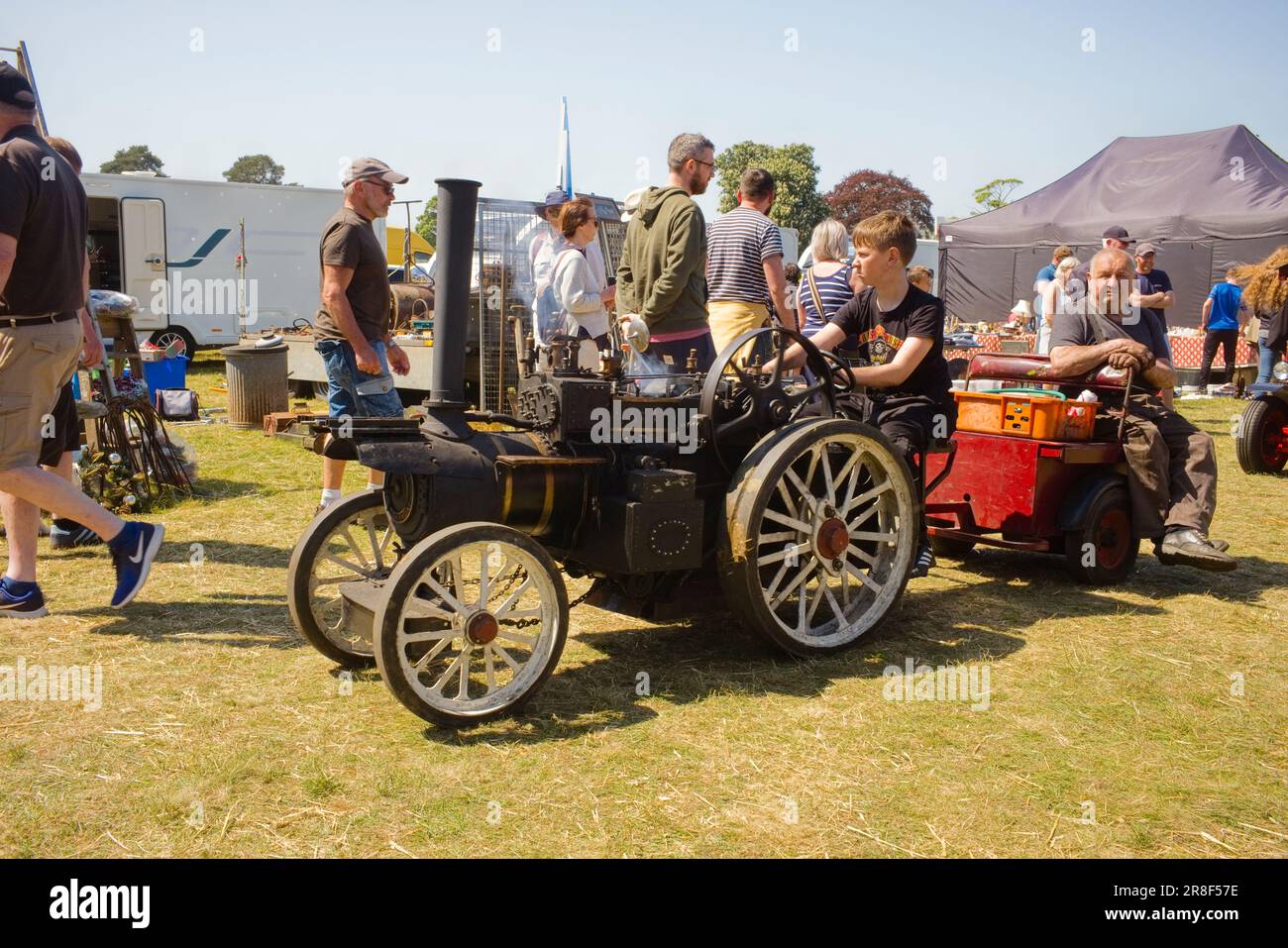 A younger person driving a miniature traction engine at the Scampton ...