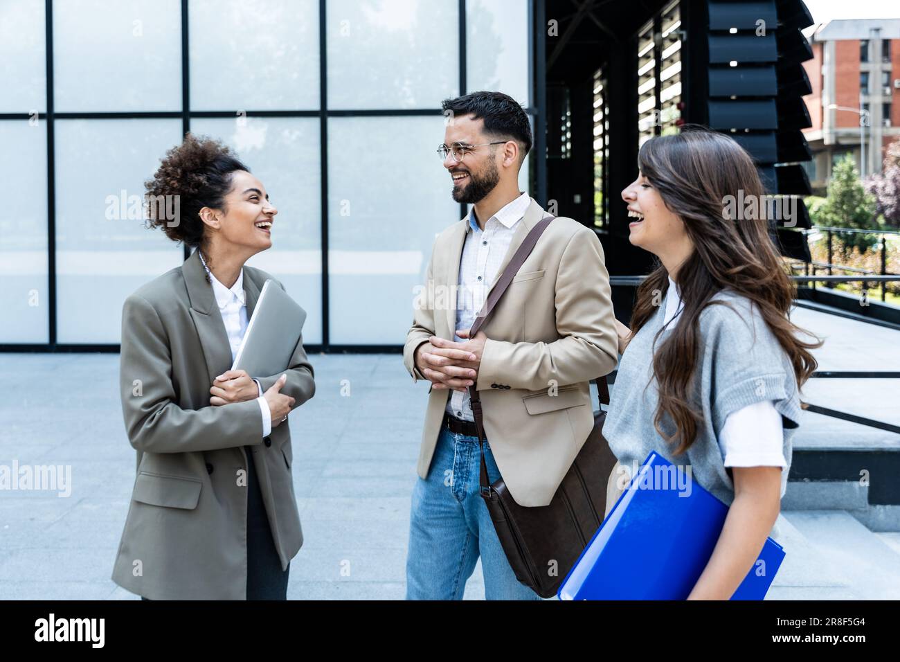 Quick briefing before meeting. Group of cheerful young successful ...