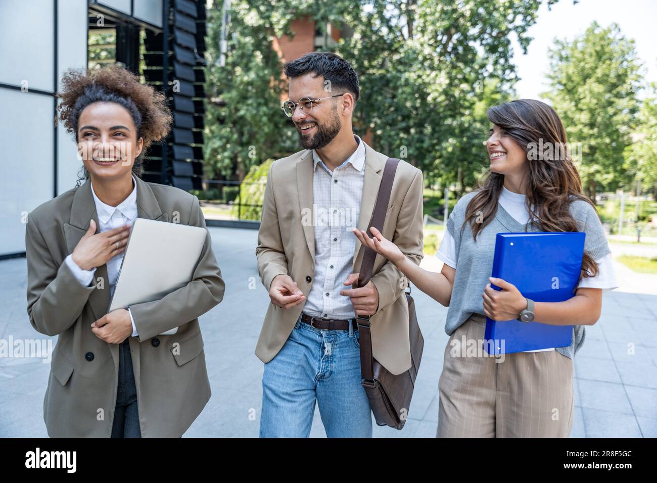 Quick briefing before meeting. Group of cheerful young successful ...