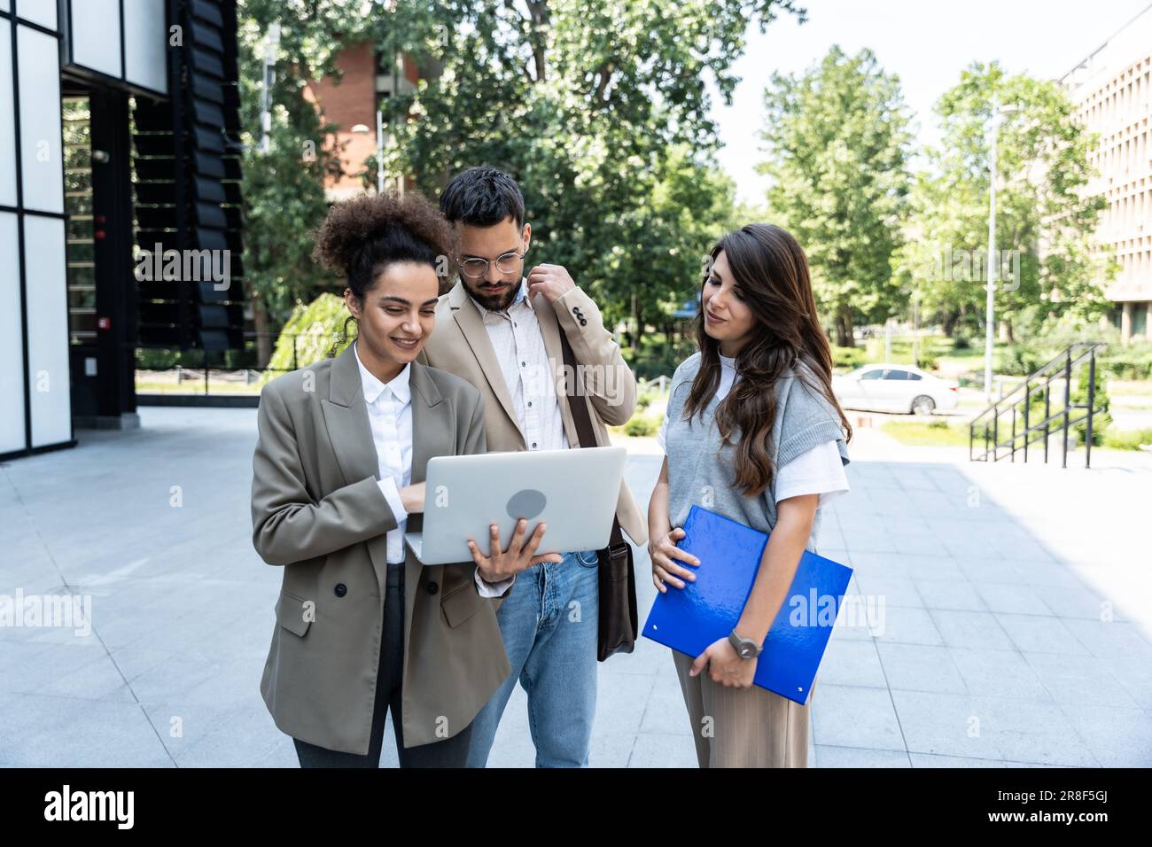 Quick briefing before meeting. Group of cheerful young successful ...
