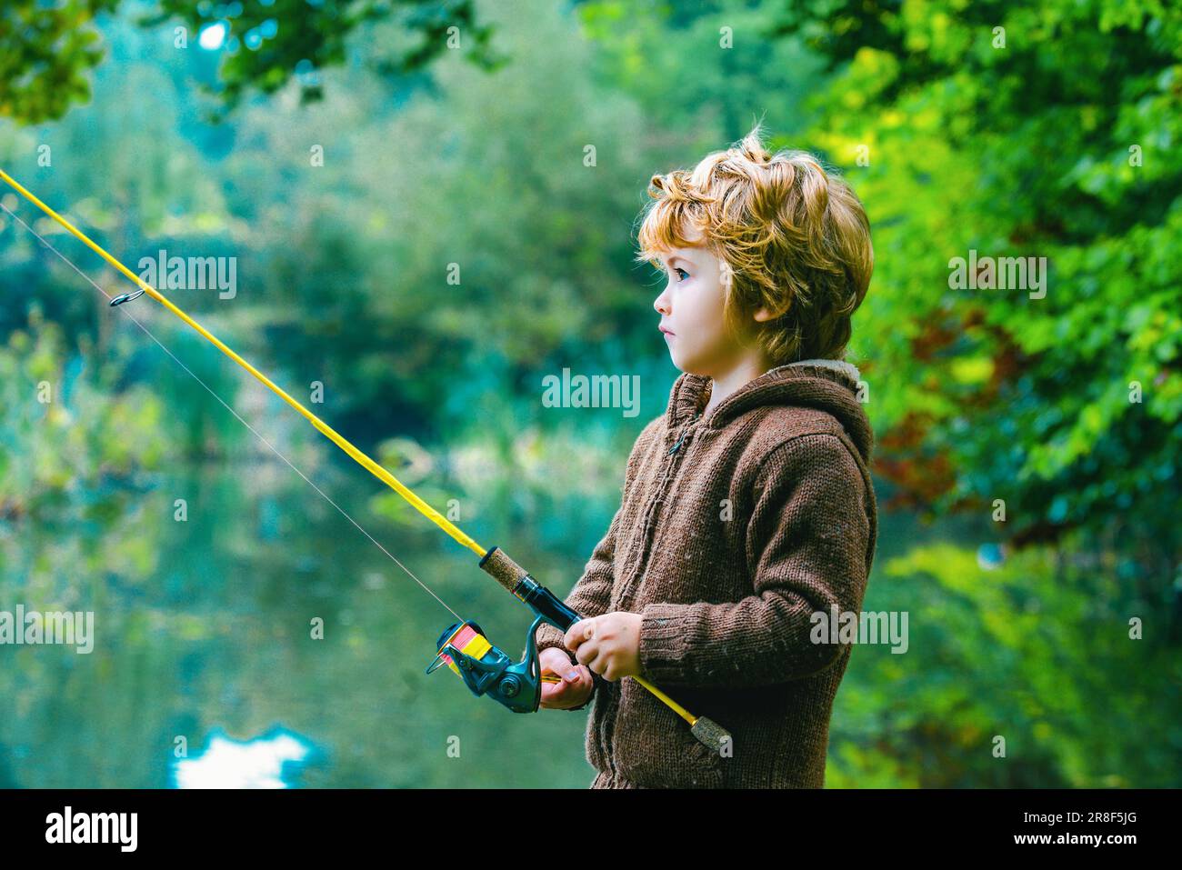 Portrait of cute child little boy fishing. Kid with spinning reel Stock ...