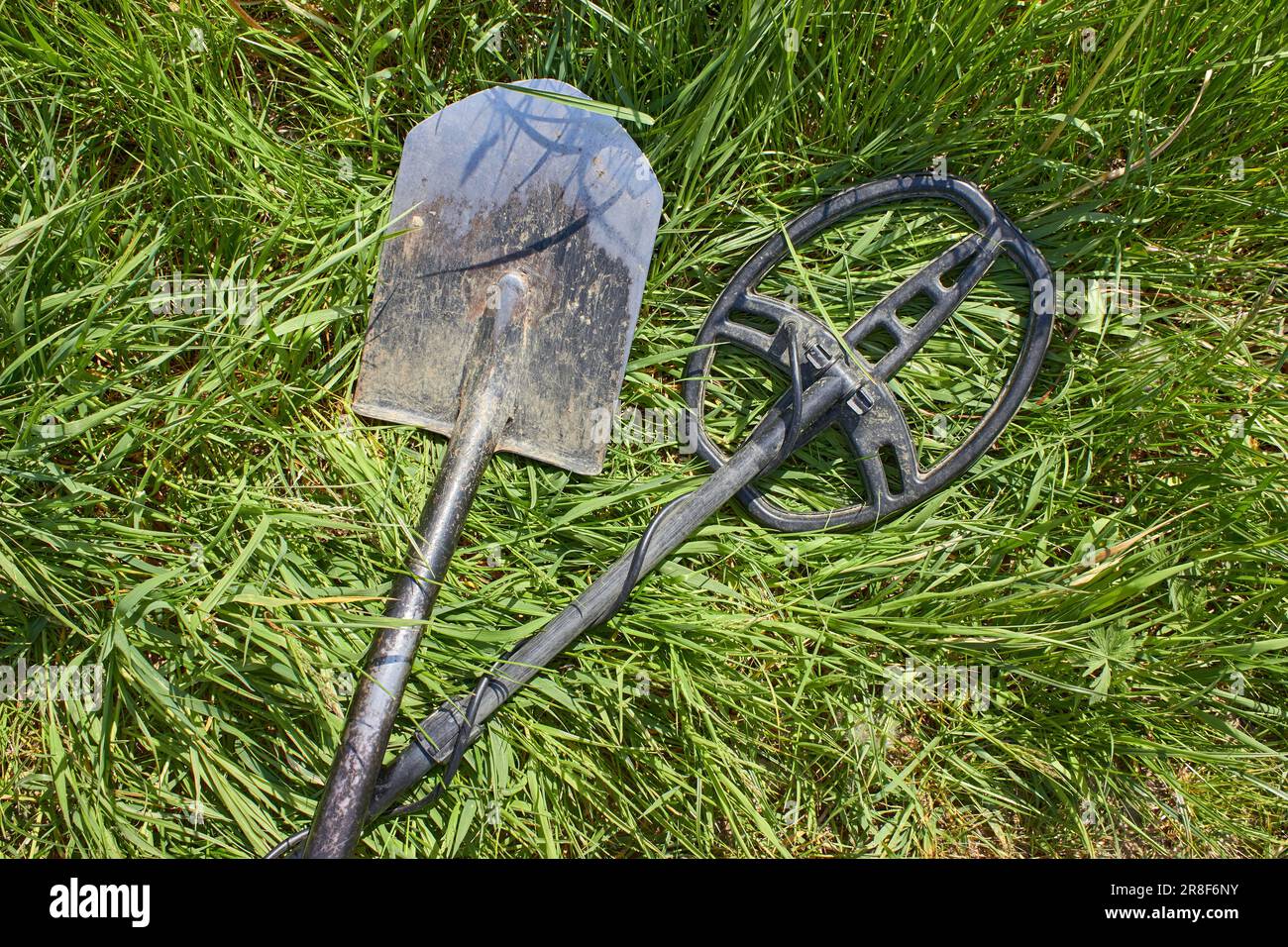 A metal detector and a shovel for searching for coins and precious ...