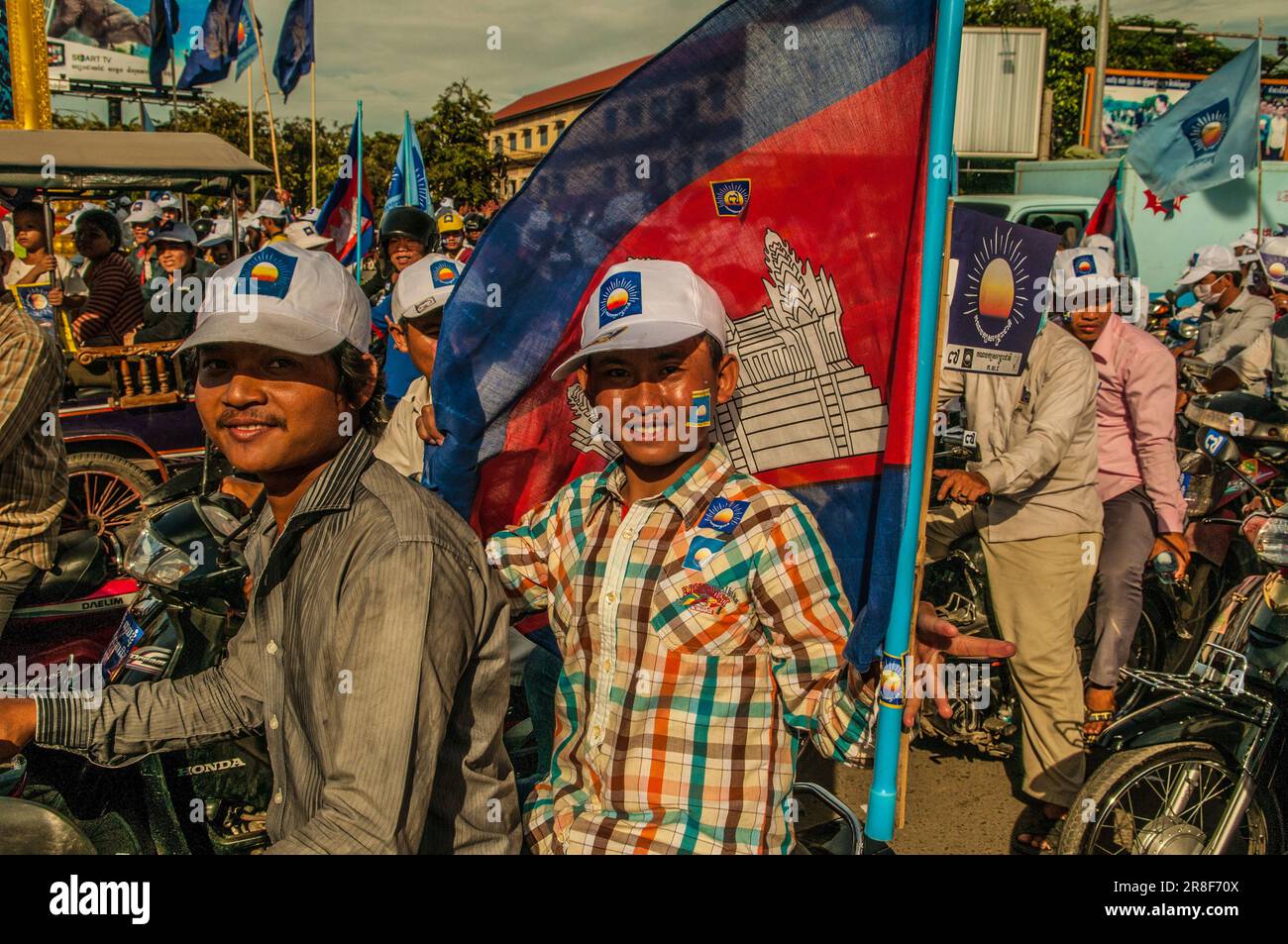 a young Sam Rainsy supporter wrapped in a Cambodian flag at a political ...