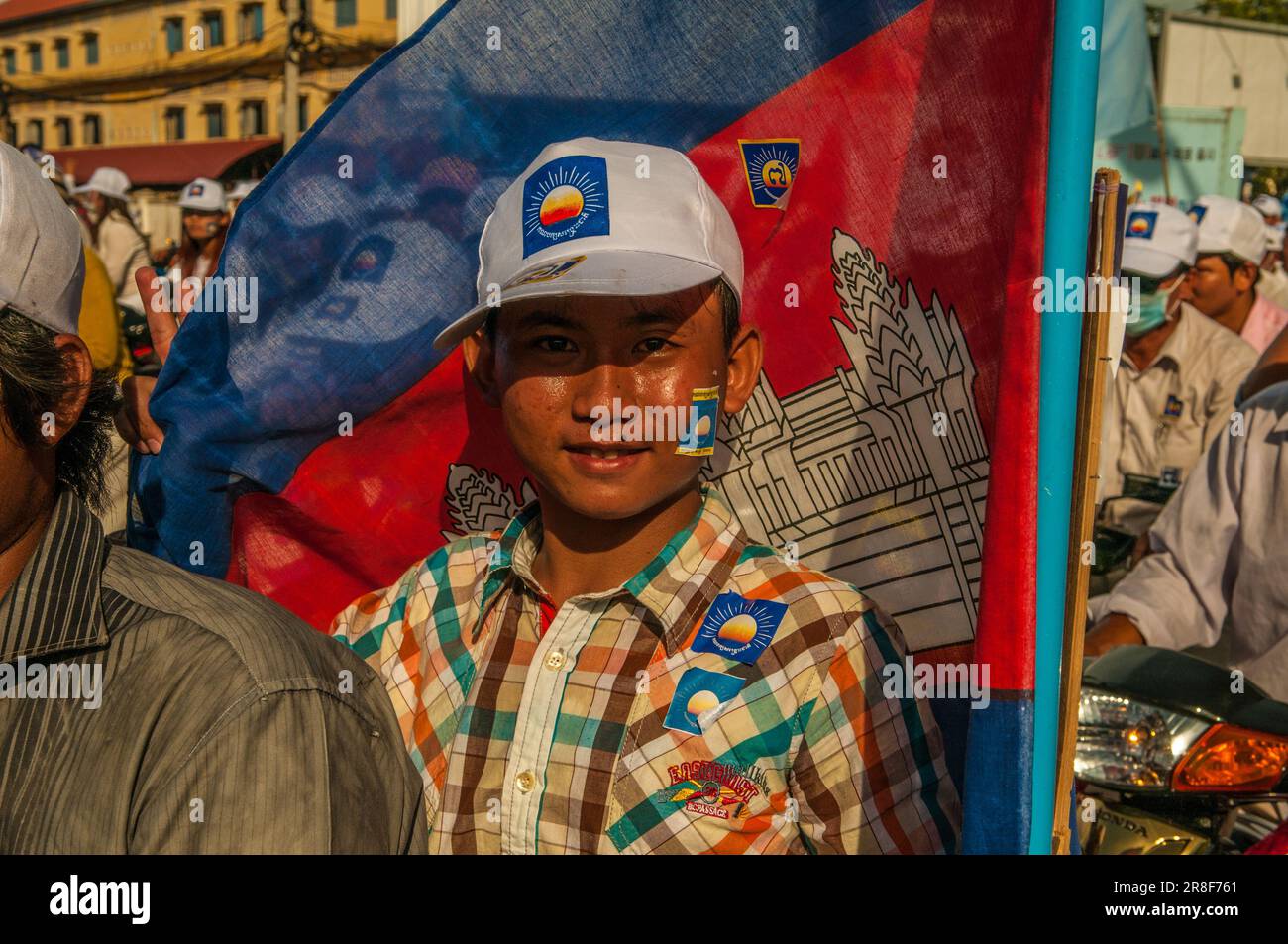 a young Sam Rainsy supporter wrapped in a Cambodian flag at a political ...