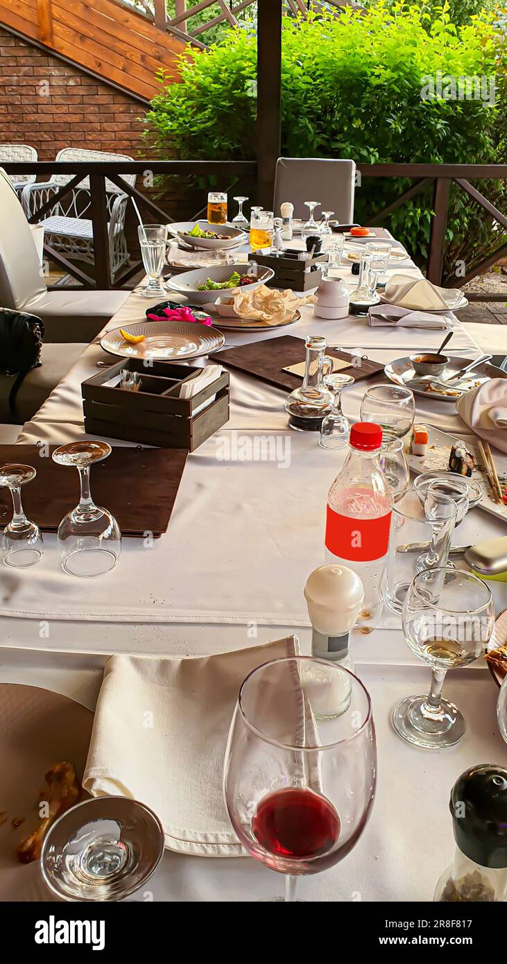 Festive table with scraps of food and dirty dishes after the banquet ...
