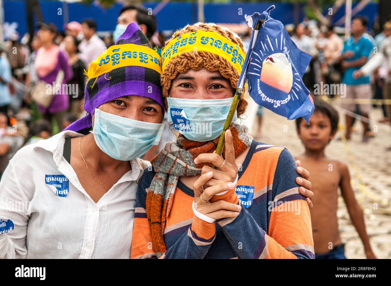 Portrait of 2 Sam Rainsy supporters wearing face masks at a political ...