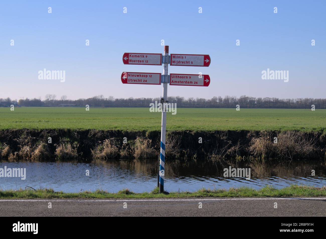 Multiple red signs showing the ways to towns in the Netherlands are ...