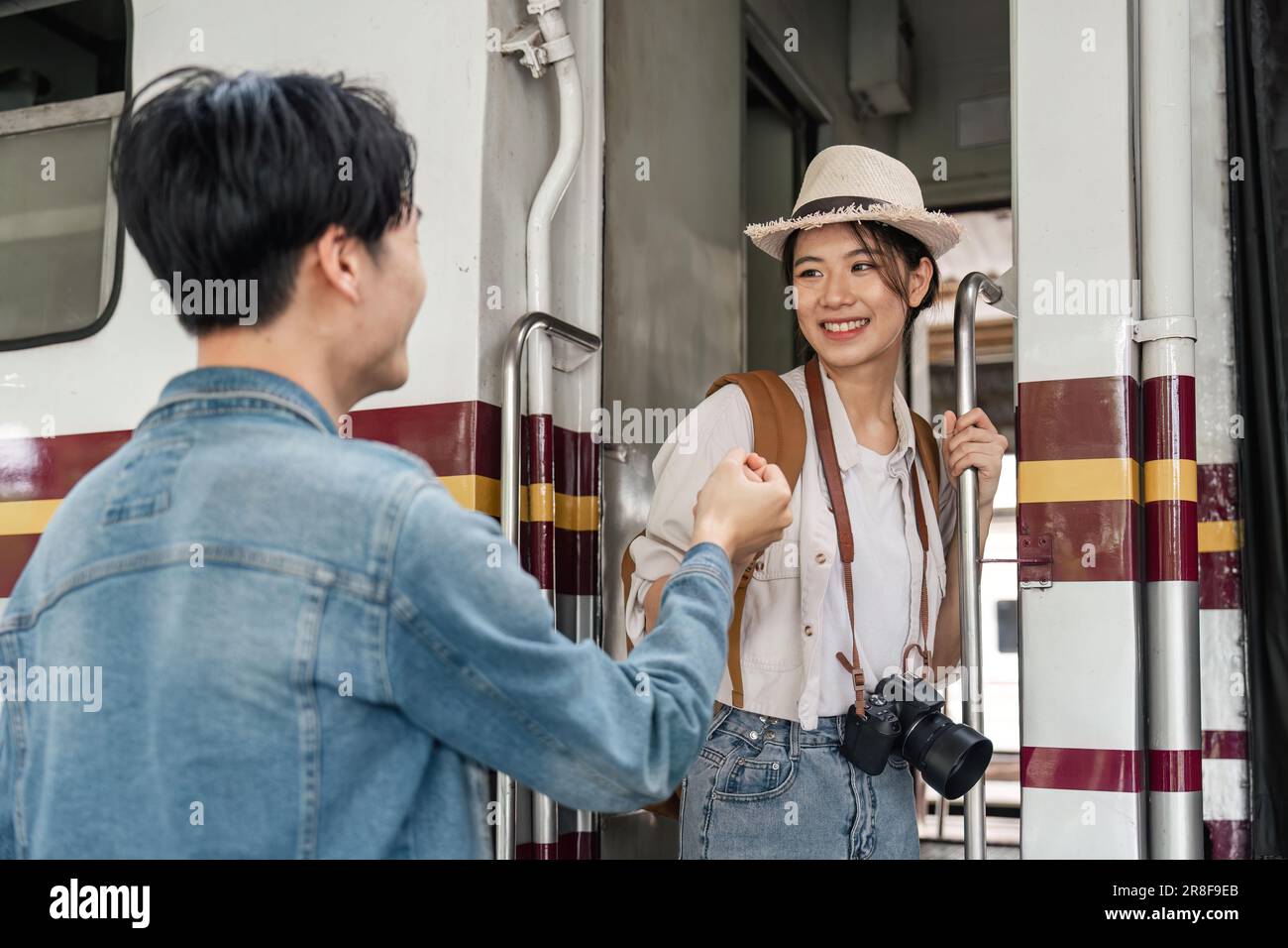 Happiness of young asian couple. A young man sends his girlfriend on a ...