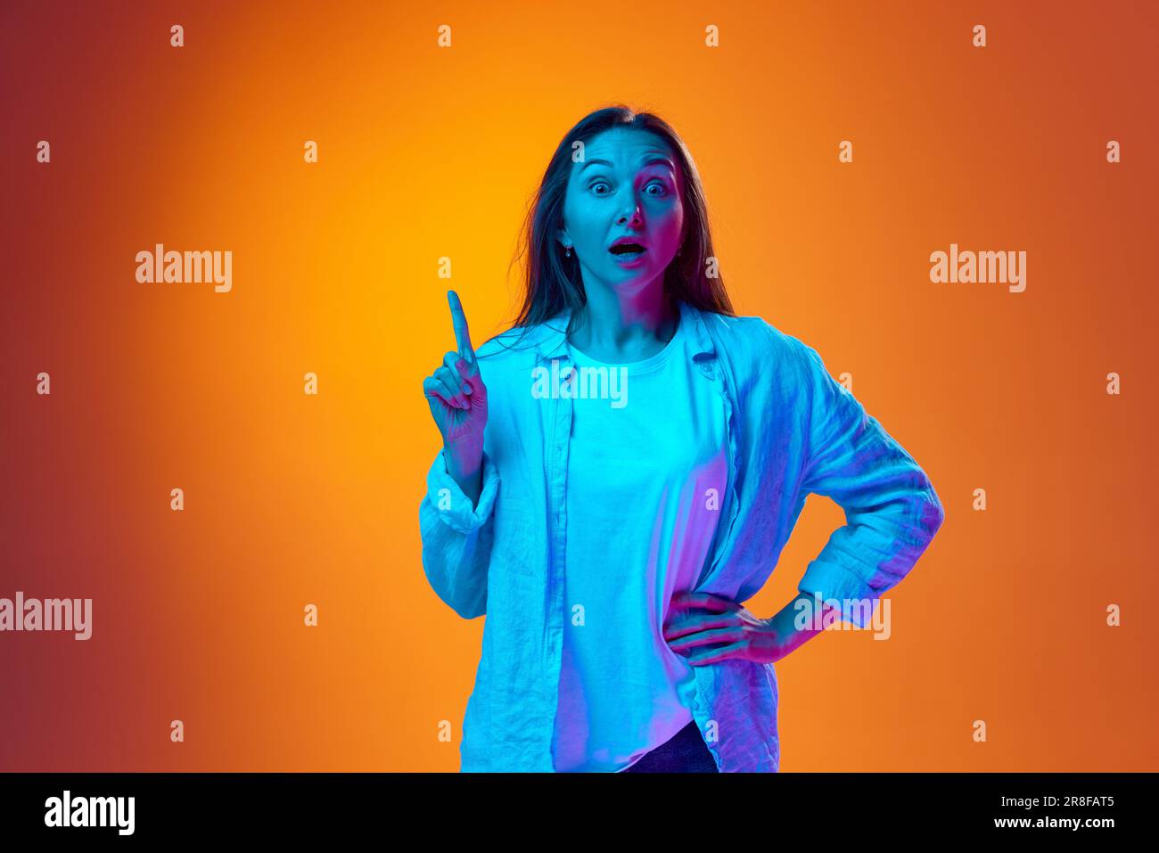Young emotional woman raising finger up meaning ideas and thoughts ...