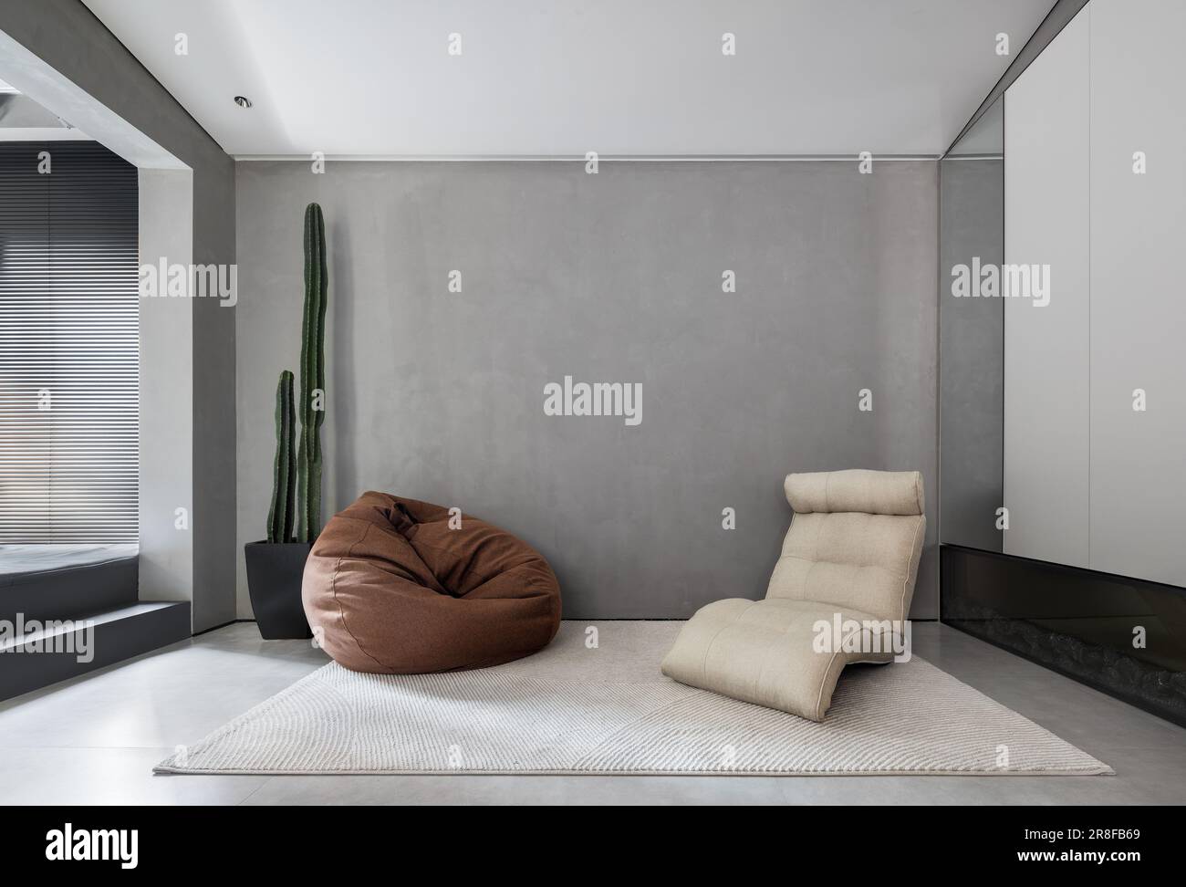 An interior of room with decorative recliner and pouf chairs situated ...