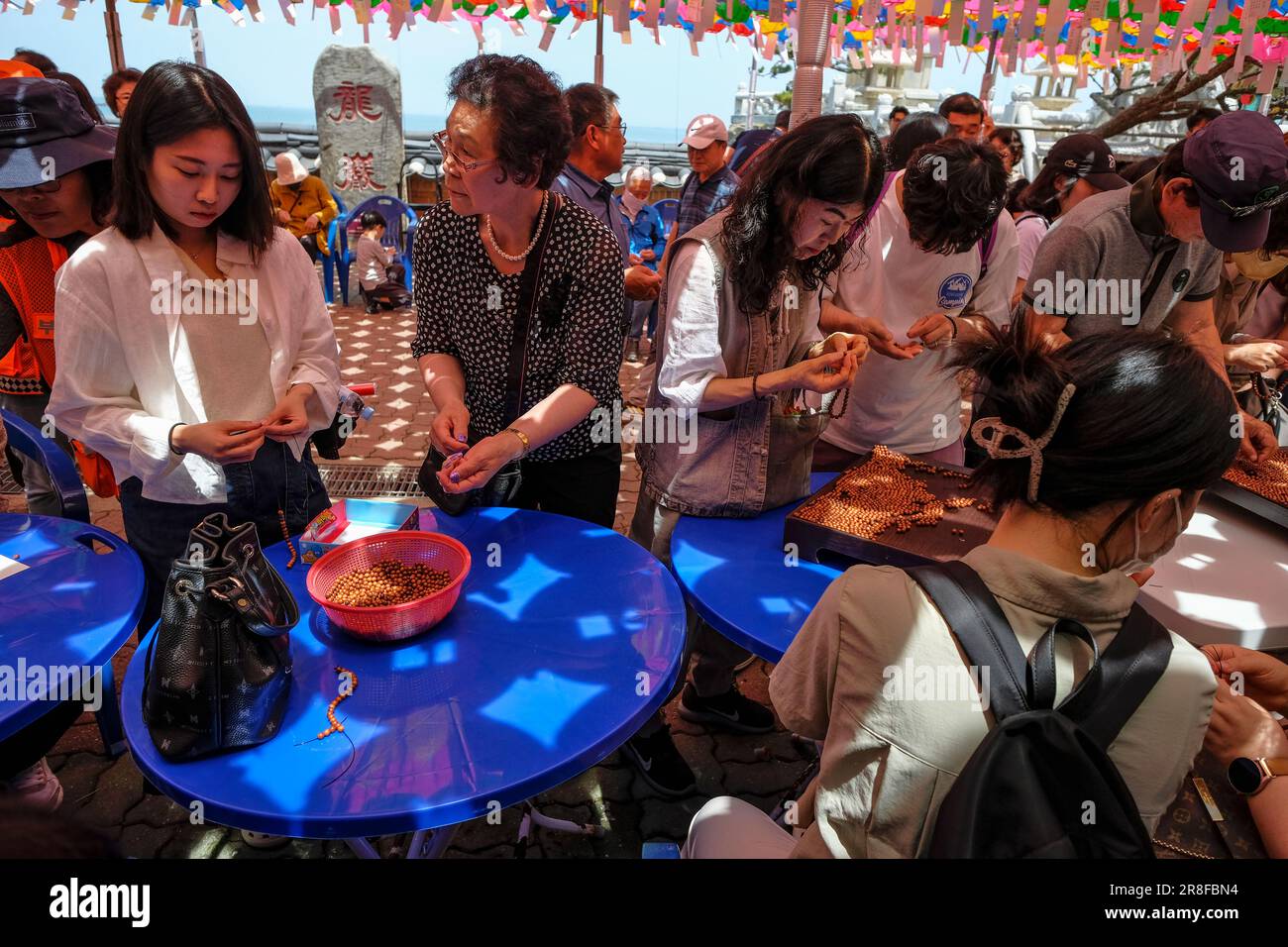 Busan, South Korea - May 27, 2023: People making bracelets in the ...