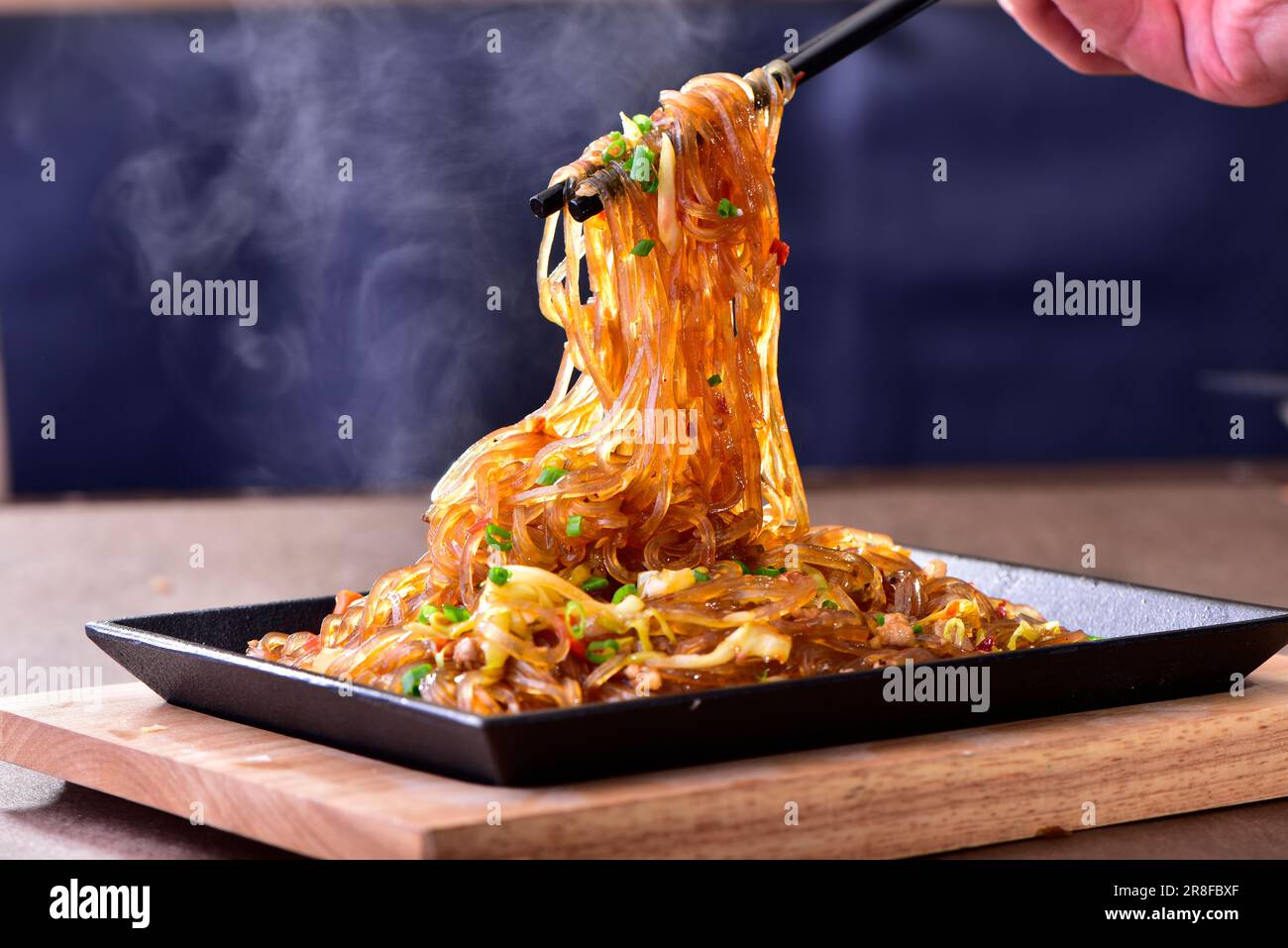 Sizzling Stir-fried Glass noodles with iron pot Stock Photo - Alamy