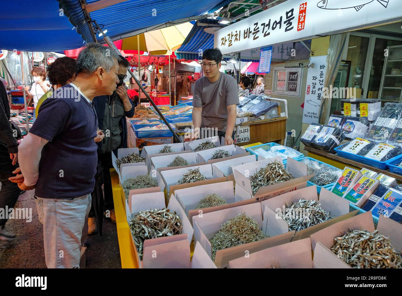 Busan, South Korea - May 28, 2023: A man selling dried fish in Jagalchi ...