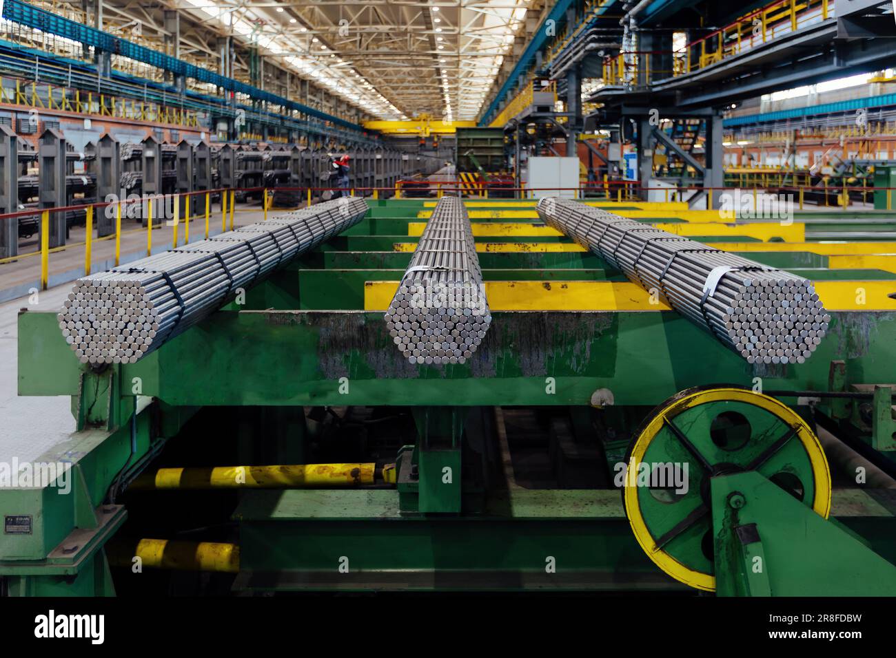 Packs of rolled metal bars on roller conveyor Stock Photo - Alamy