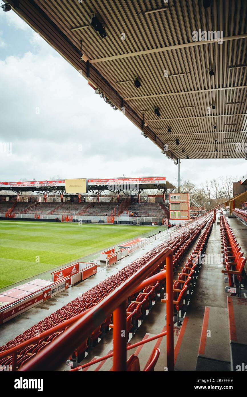 A picture of a large football stadium with the stands full of vibrant ...