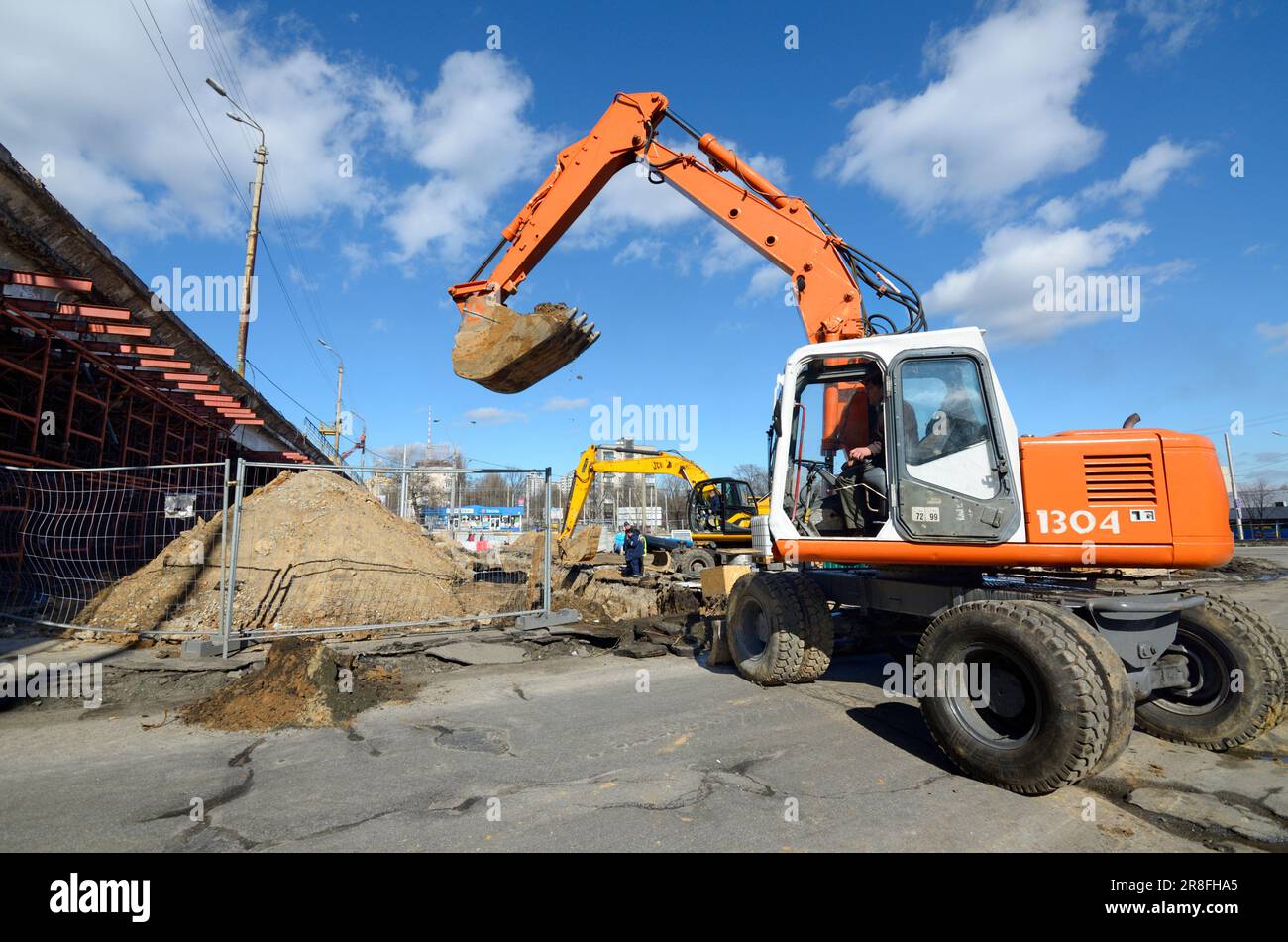 wheel excavator digging pile of ground, construction site Stock Photo ...