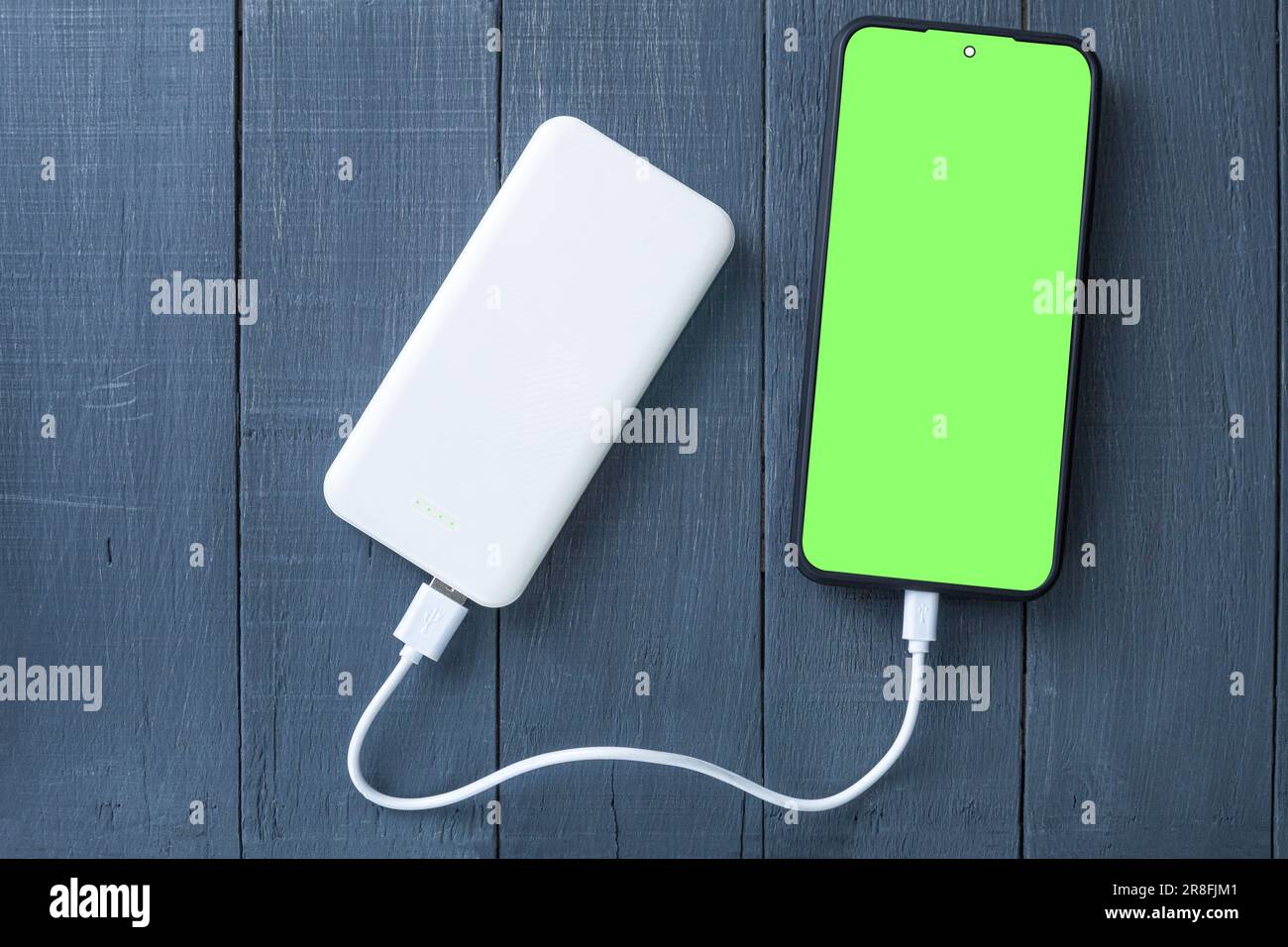 Phone with chroma key screen, wooden background. Copy space. Photo of a ...