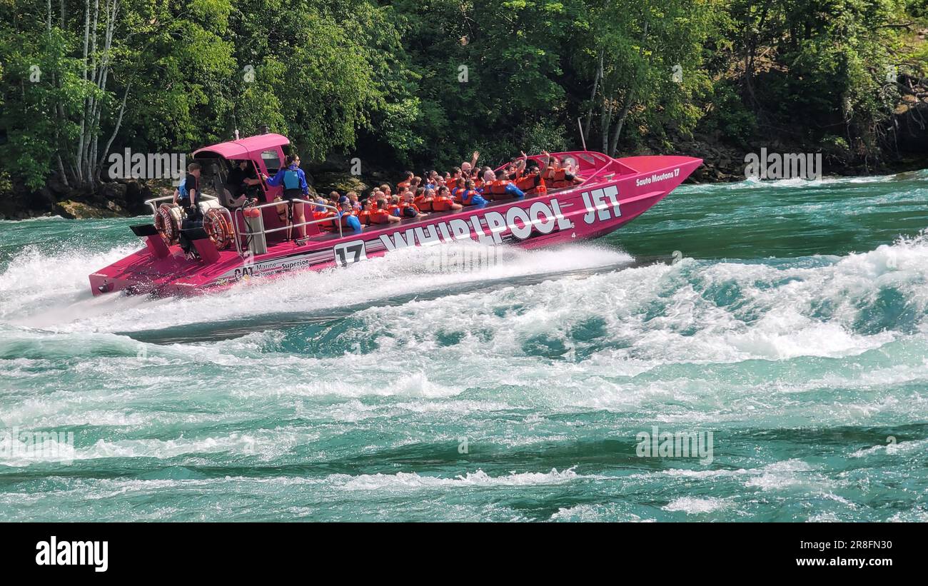 A group of tourists enjoying a sightseeing cruise with a Whirlpool jet ...