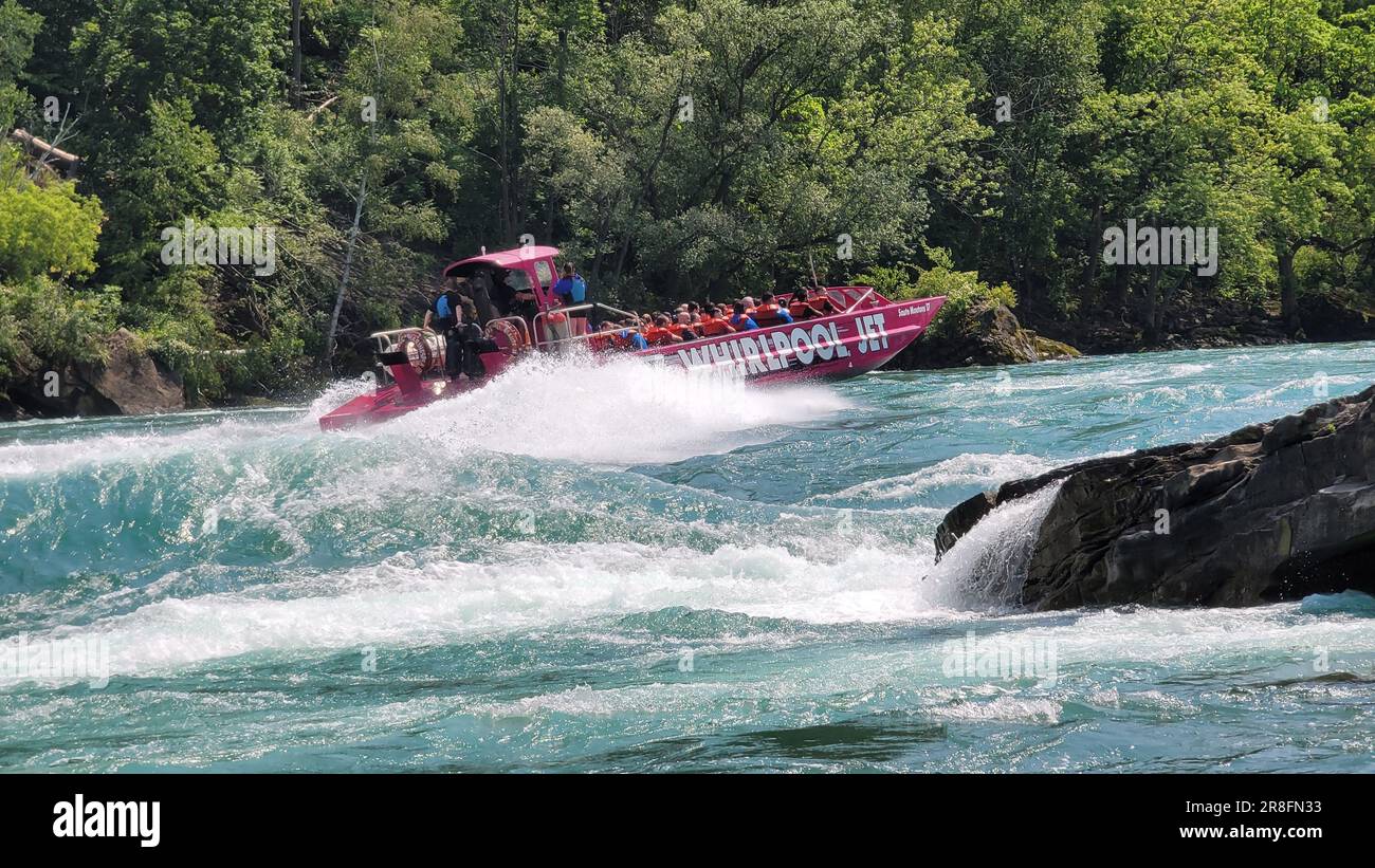 A group of tourists enjoying a sightseeing cruise with a Whirlpool jet ...