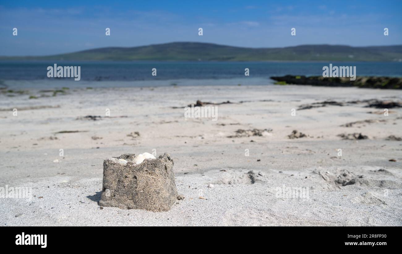 Small sandcastle on a sandy beach in Orkney, Scotland, UK Stock Photo ...