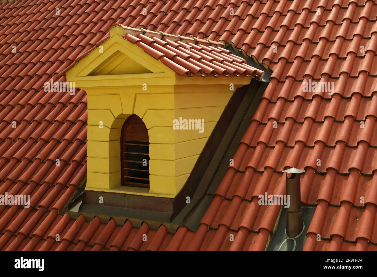 A traditional red tiled roof with a small window Stock Photo - Alamy