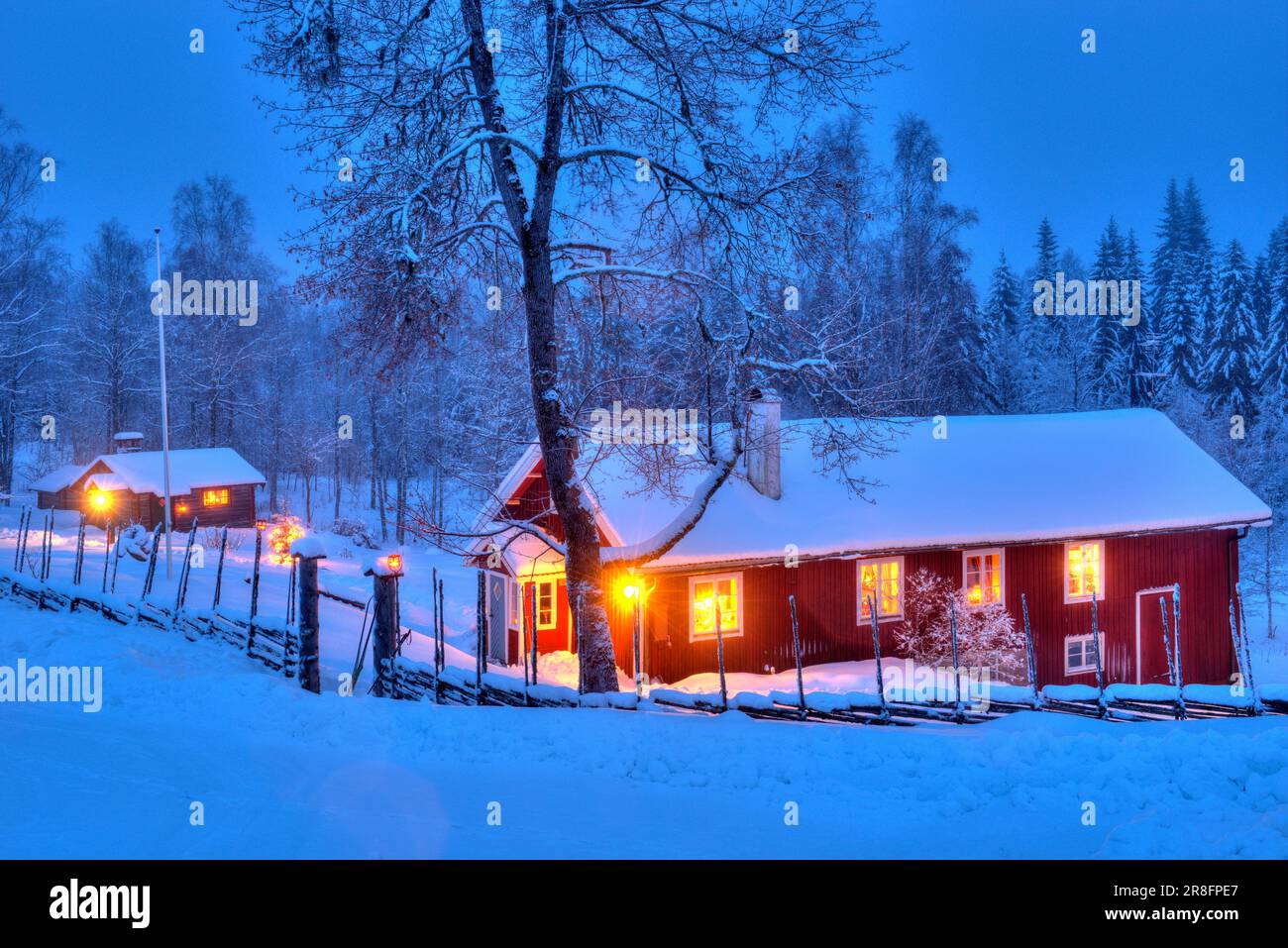 A falu red house with lights in the windows in a winter night Stock ...